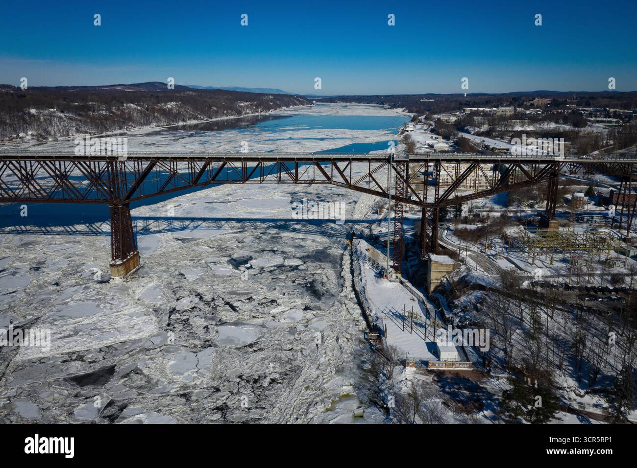 Aerial view of the Rip Van Winkle Bridge cutting across the icy, frozen ...