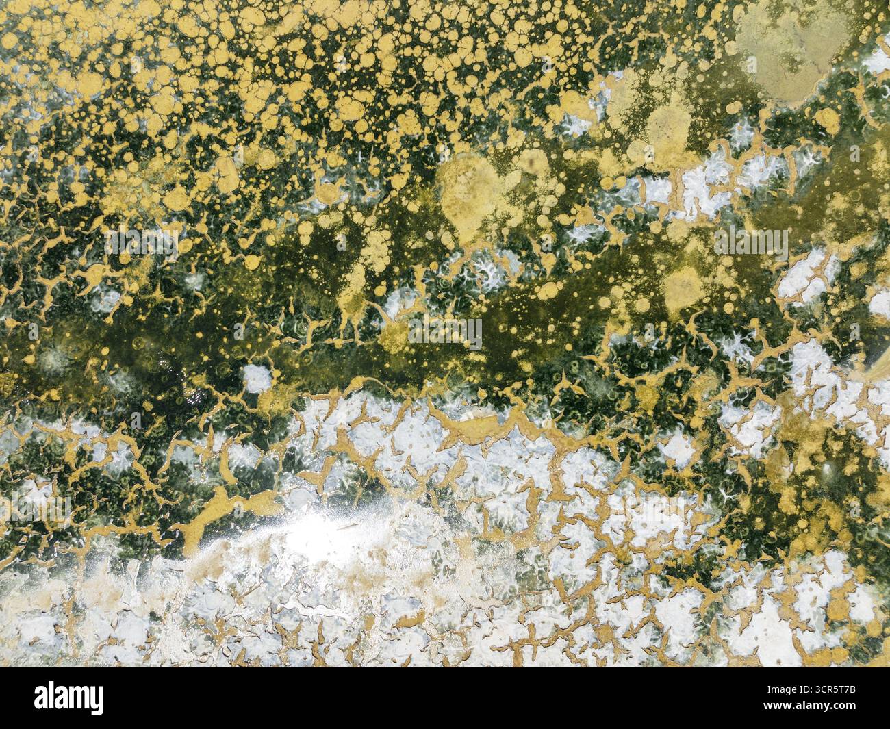 Aerial view of shimmering saline ponds painted in earthy hues ...
