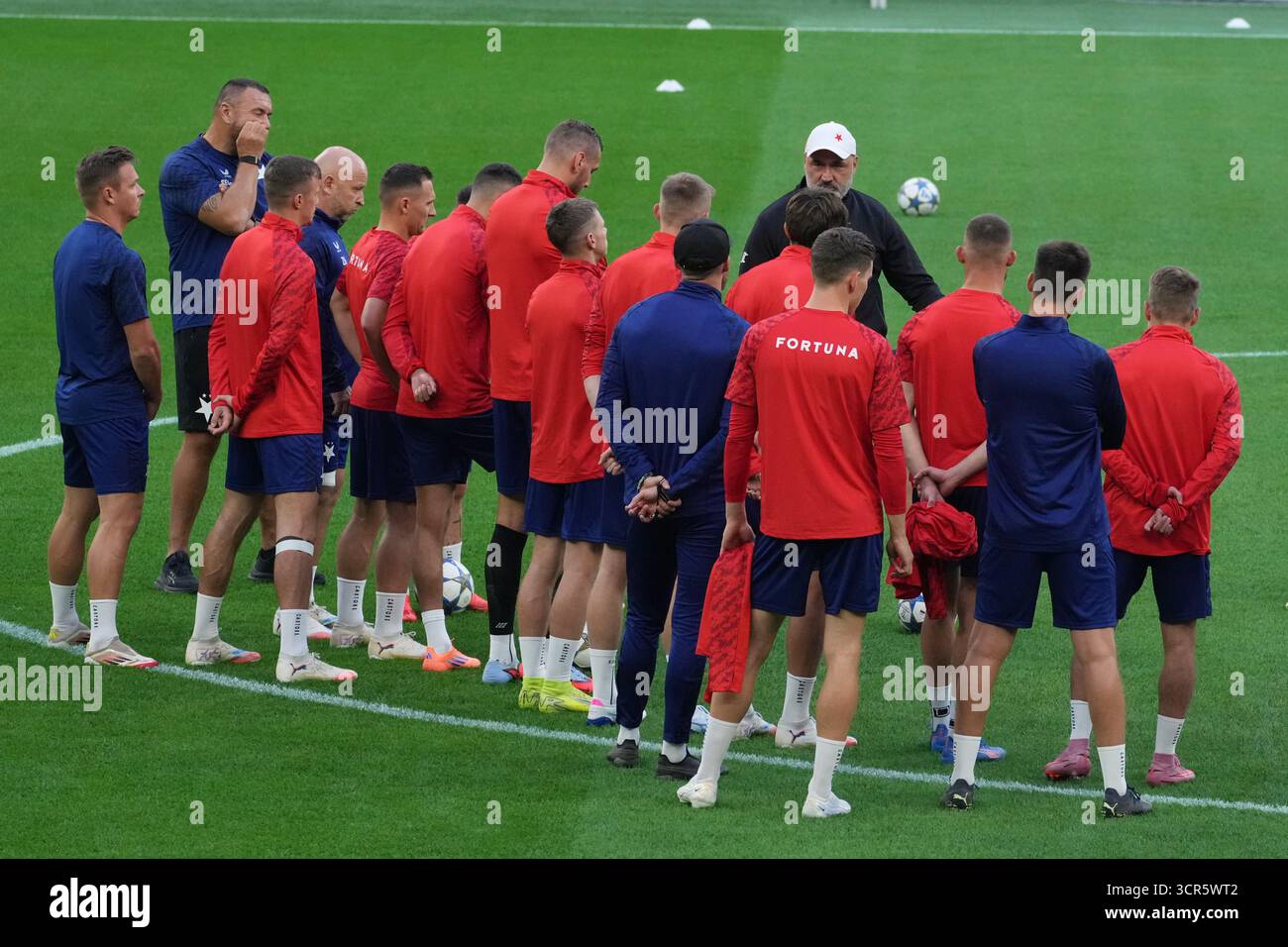 Slavia's head coach Jindrich Trpisovsky talks with his players during a ...