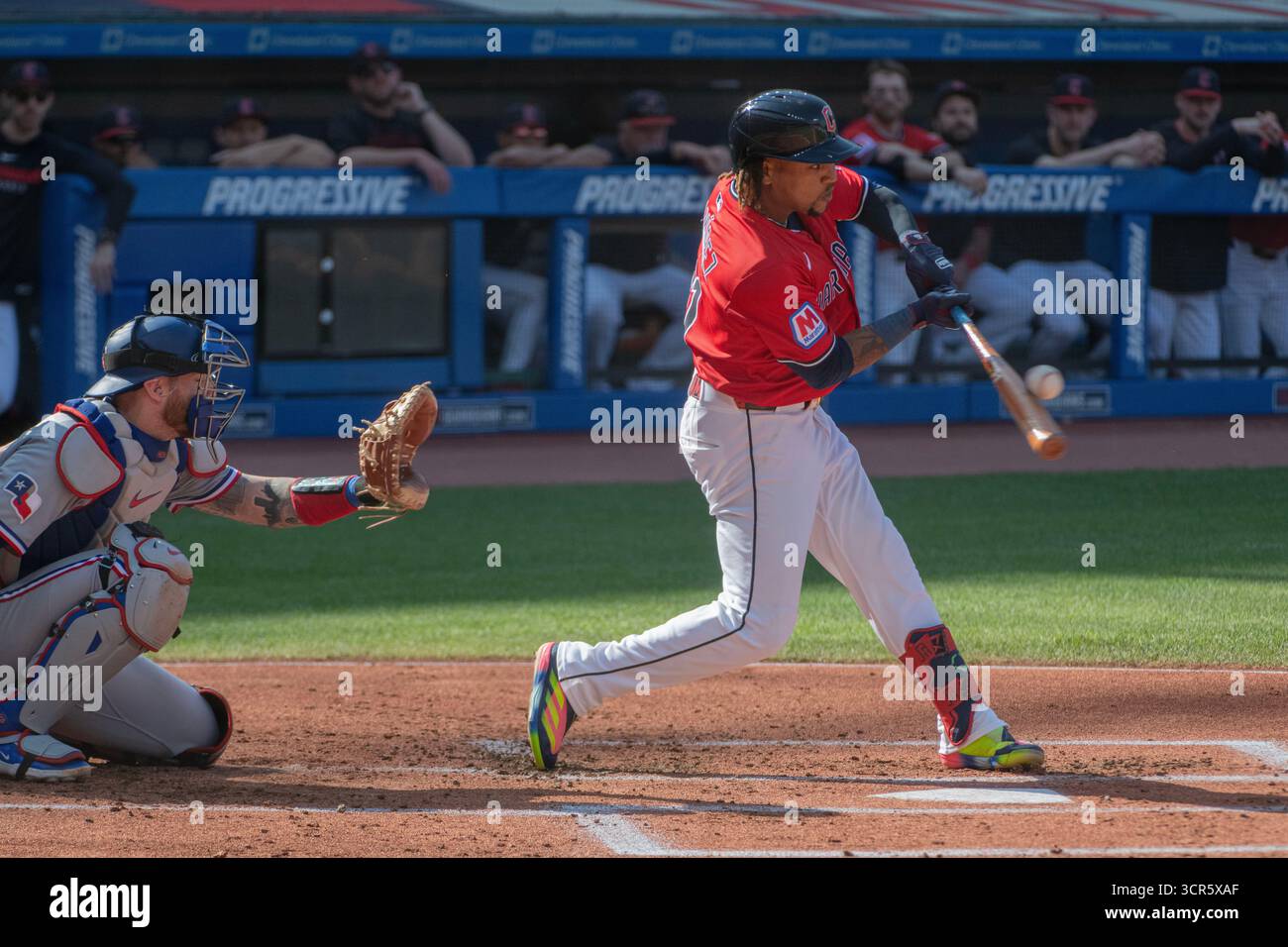 Cleveland Guardians' Jose Ramirez, right, connects with a Texas Rangers ...