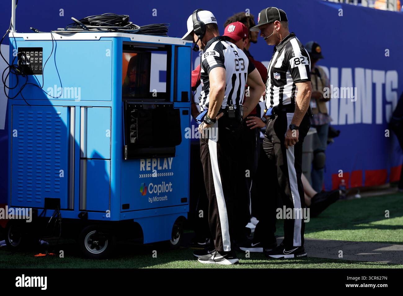 Referee Shawn Hochuli (83) and back judge Jimmy Russell (82) review a ...