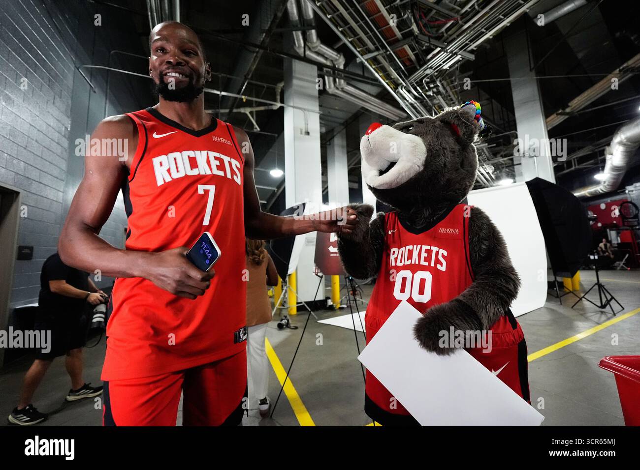 Houston Rockets forward Kevin Durant (7) jokes greets mascot Clutch ...