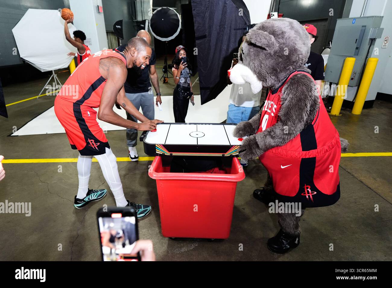Houston Rockets forward Kevin Durant, left, plays air hockey with ...