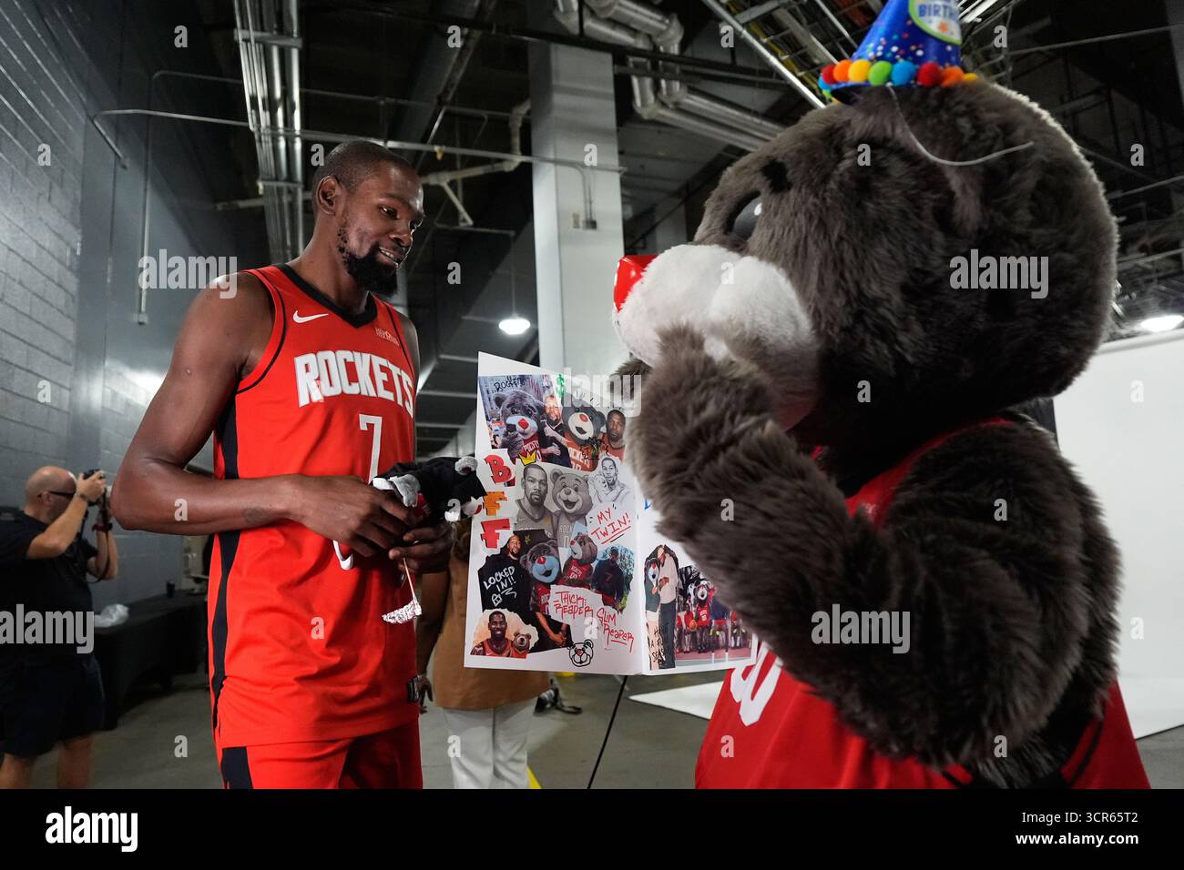 Houston Rockets forward Kevin Durant (7) jokes greets mascot Clutch ...