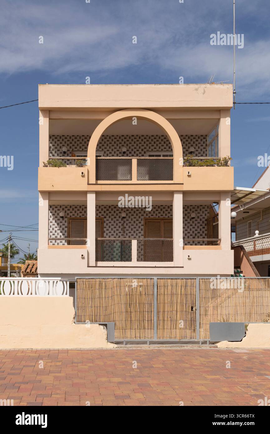 View of a two-story house, with a typical 1970s beach construction. The ...