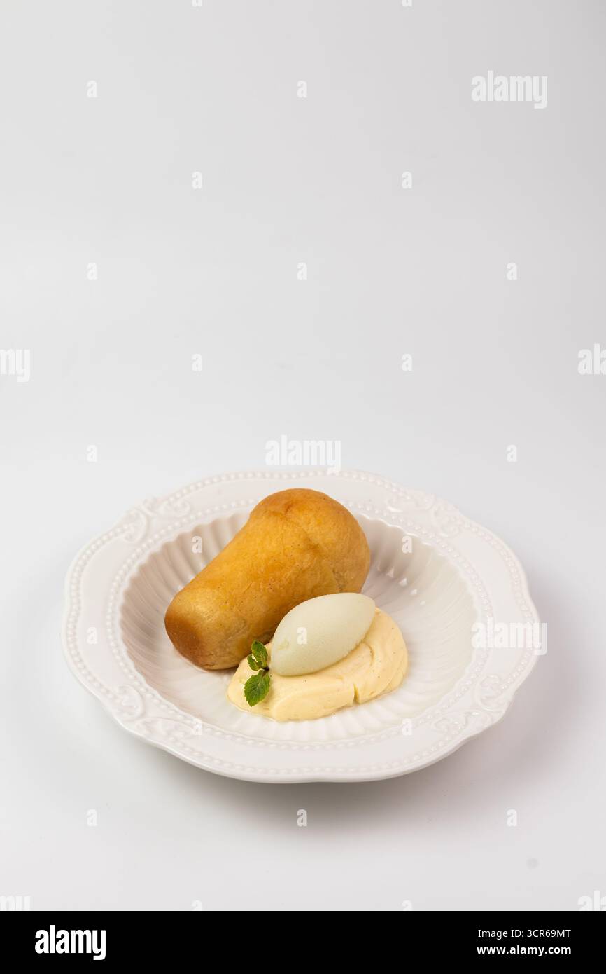 Elegant serving of Neapolitan rum baba dessert with creamy custard and ...