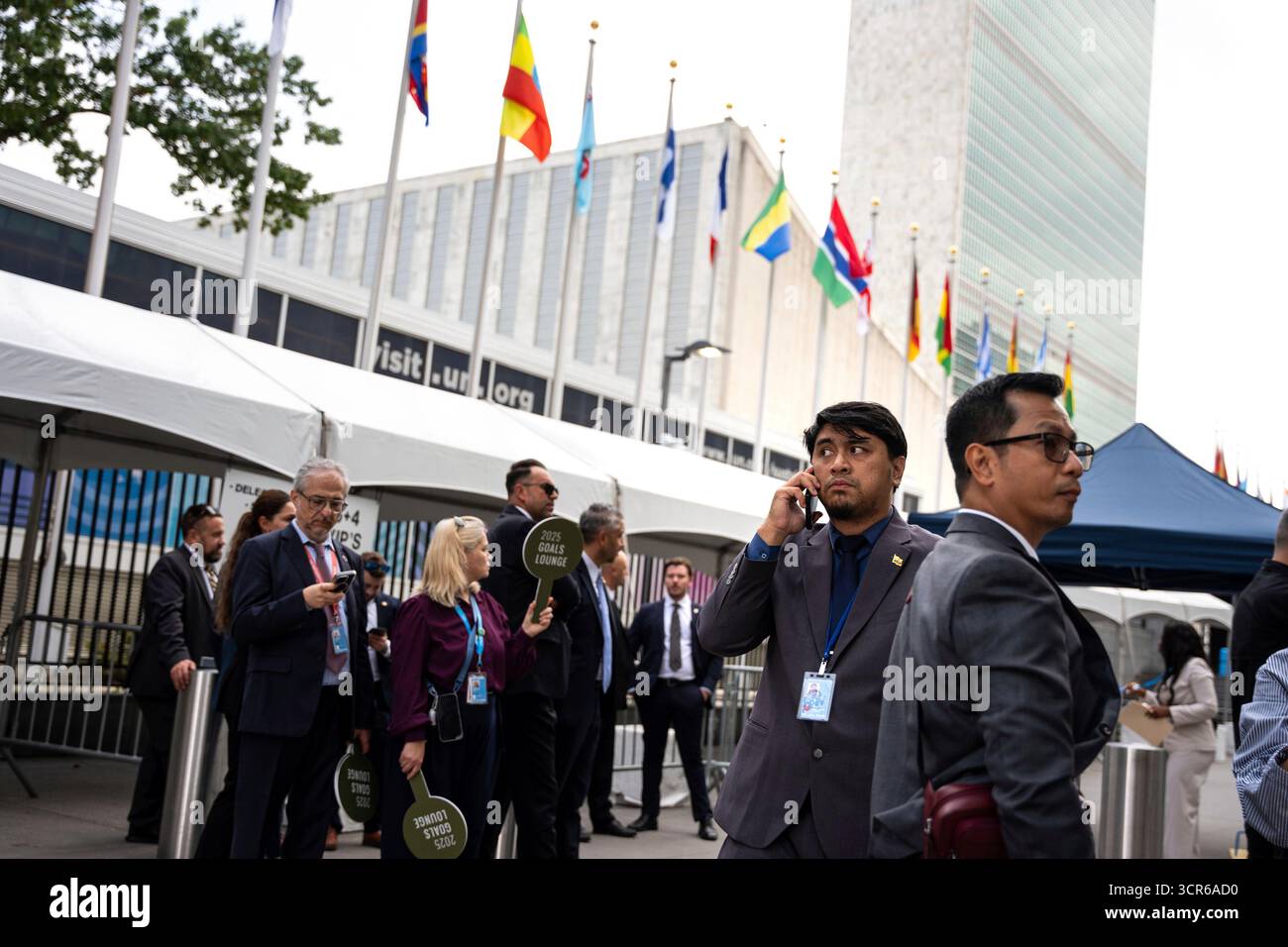 FILE - People stand outside the United Nations Headquarters on the ...