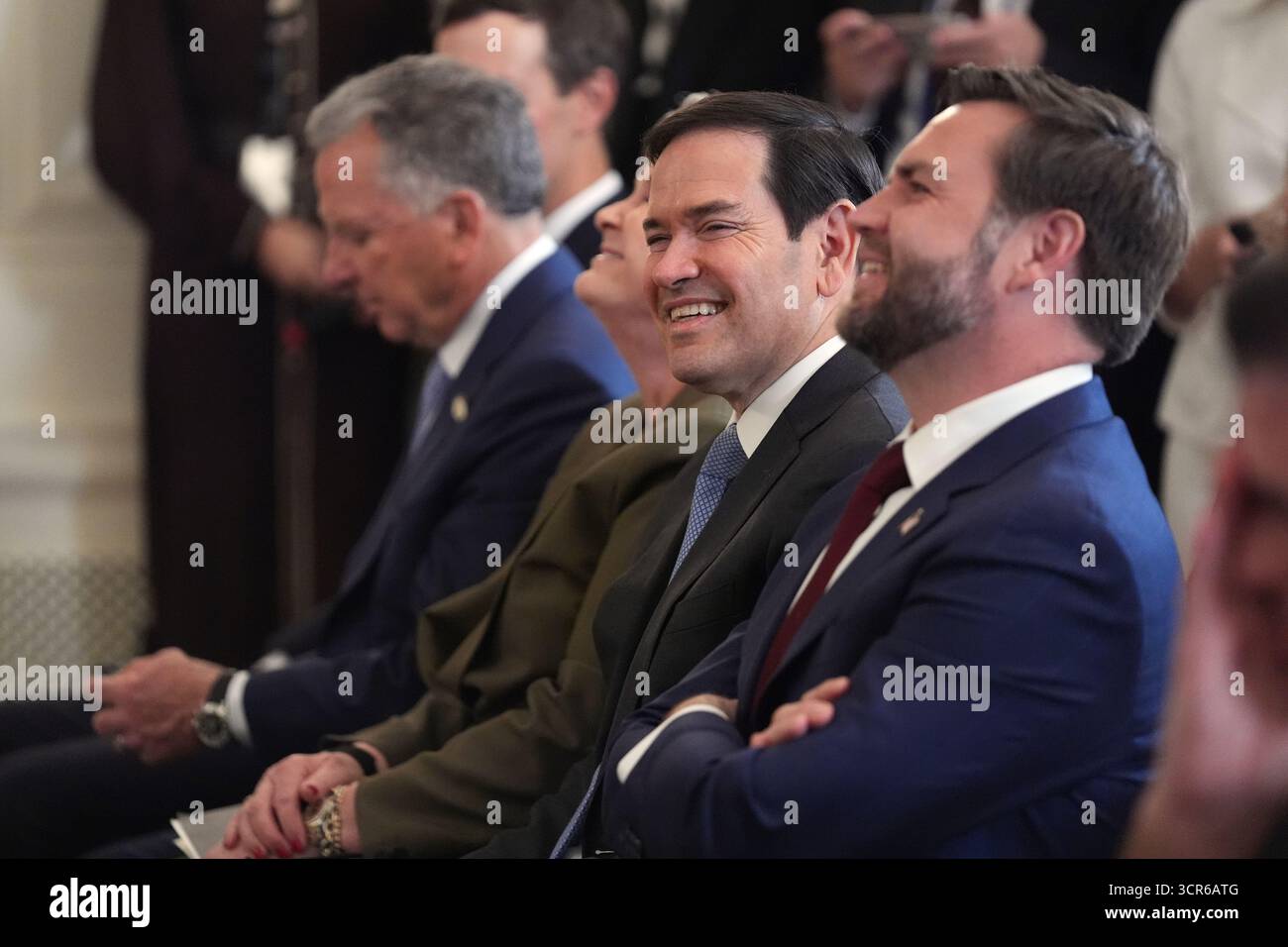 Secretary of State Marco Rubio, second right, reacts alongside Steve ...