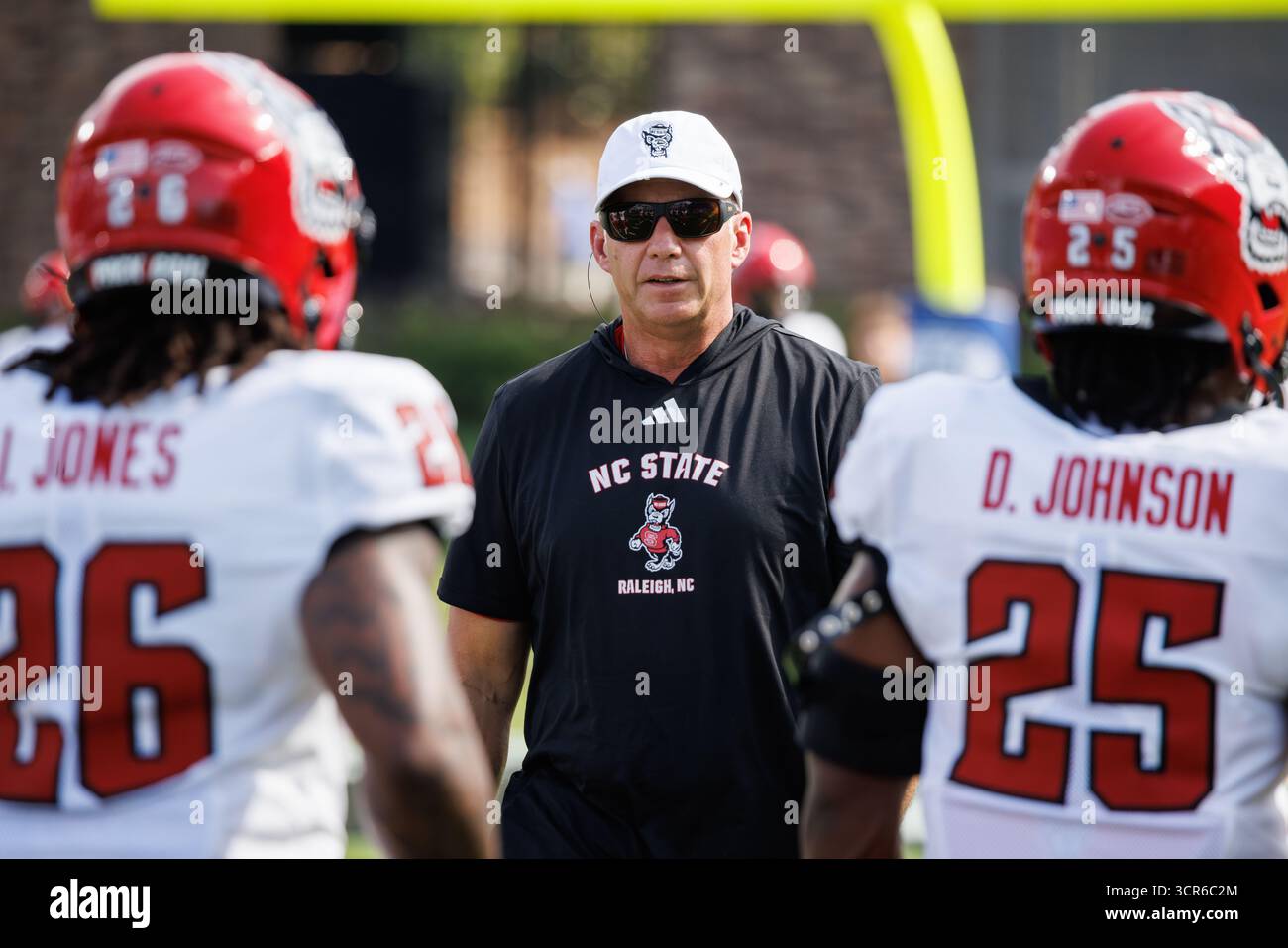 North Carolina State head coach Dave Doeren watches his team warm up ...