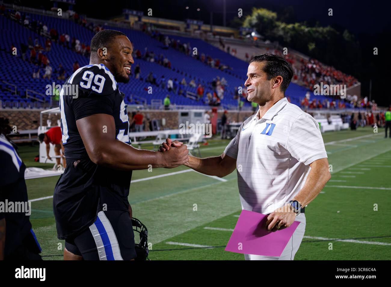 Duke head coach Manny Diaz celebrates with Duke's Aaron Hall (99) after ...