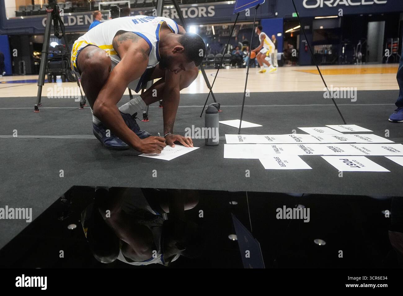 Golden State Warriors' Marques Bolden writes his name on a piece of ...