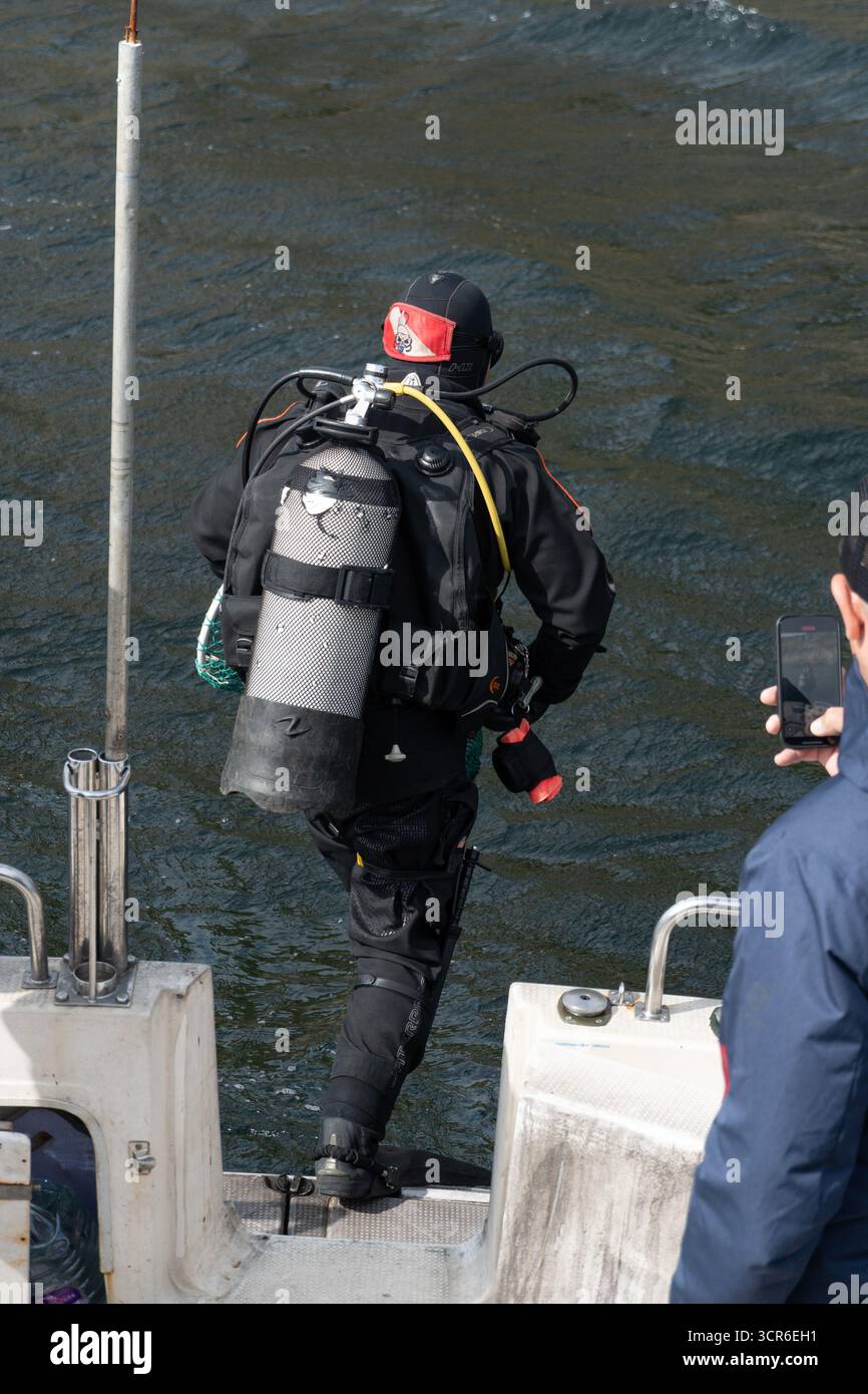 Barents Sea, Russia - June 14, 2025: Diver in full scuba gear prepares ...