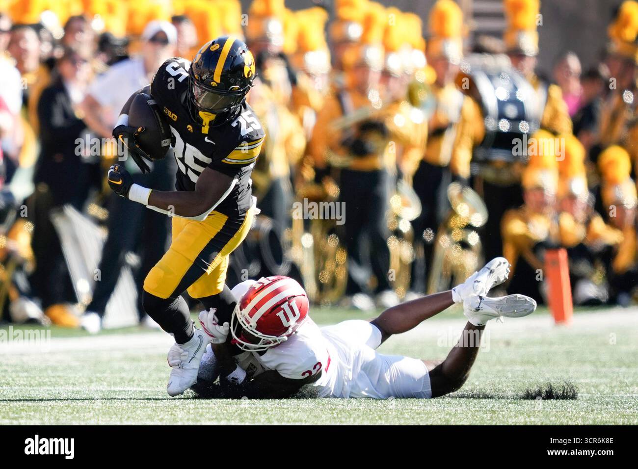 Iowa running back Nathan McNeil (25) tries to break a tackle by Indiana ...