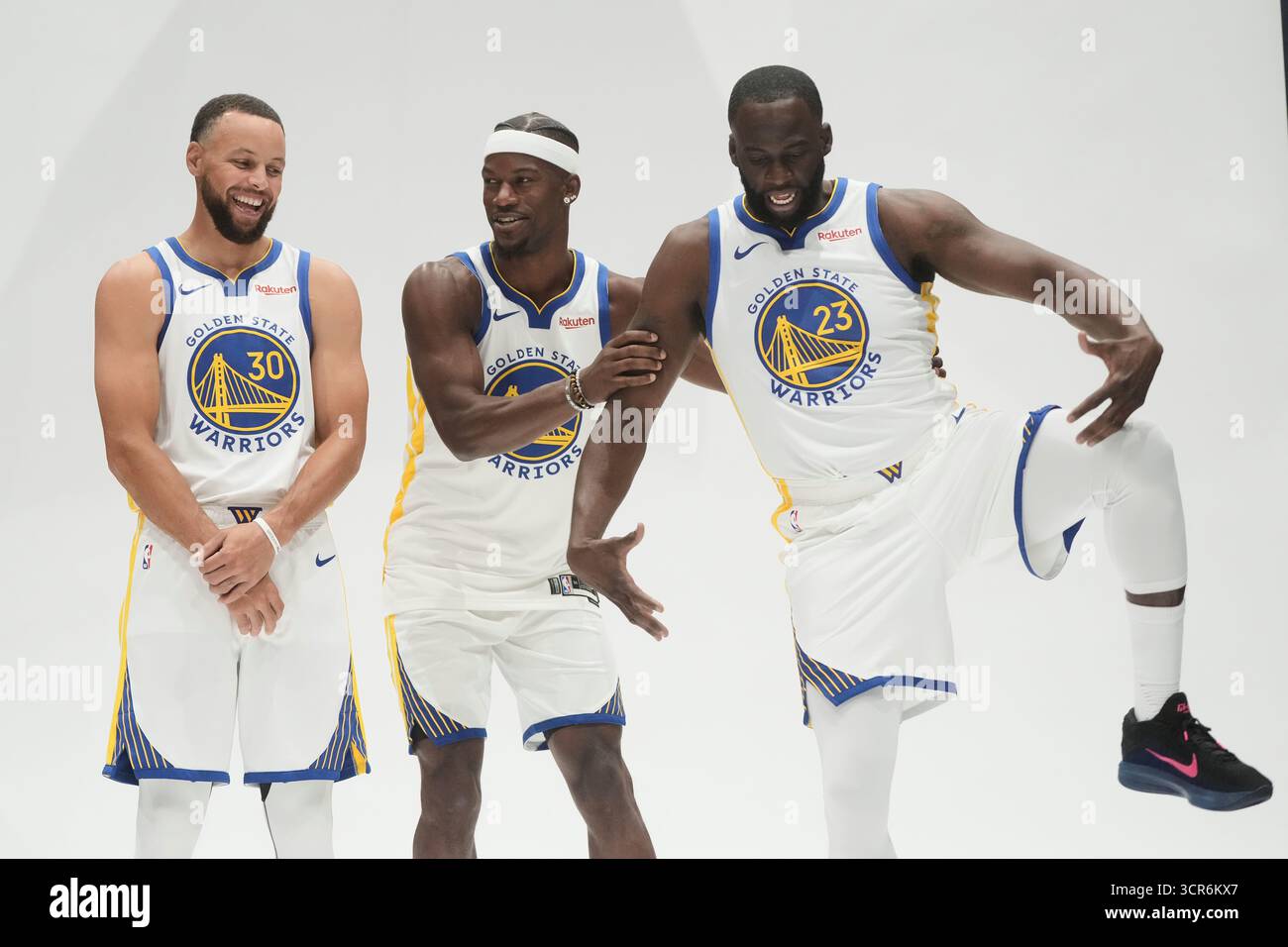 Golden State Warriors guard Stephen Curry, left, smiles while posing for photos with forward ...