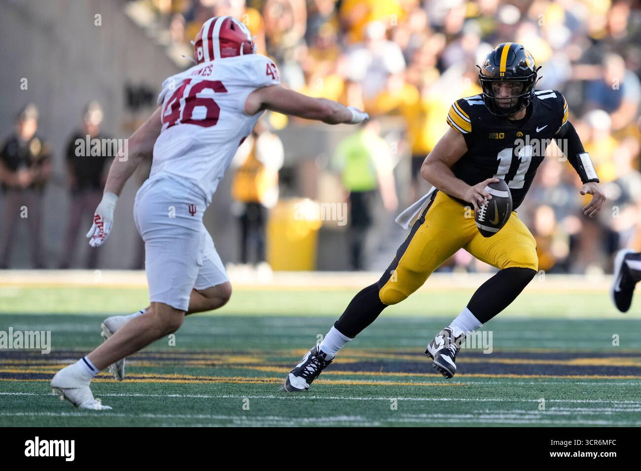 Iowa quarterback Mark Gronowski (11) runs from Indiana linebacker ...