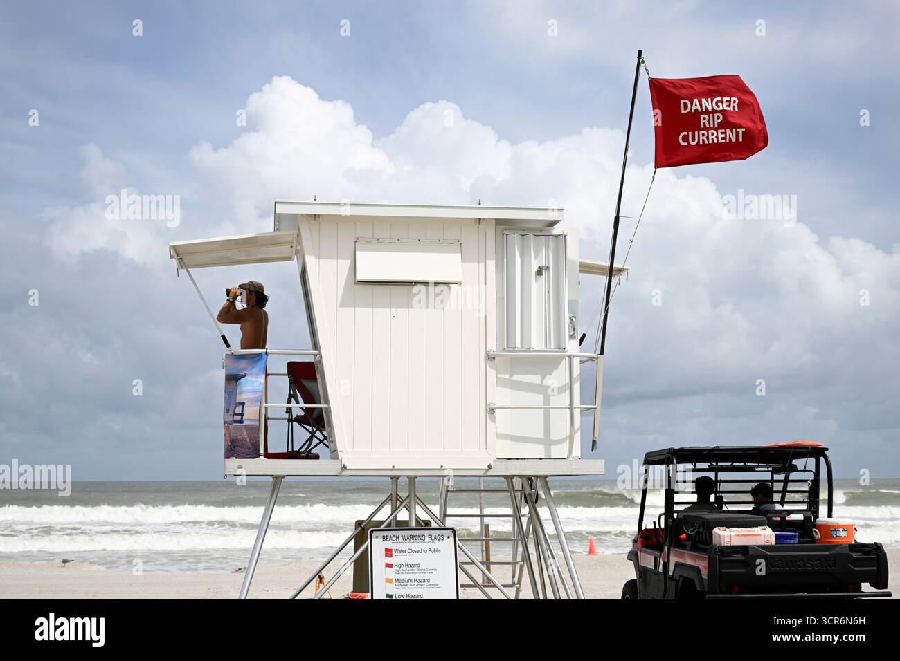 Lifeguard Cody Faust, left, watches over swimmers in the rough surf as ...