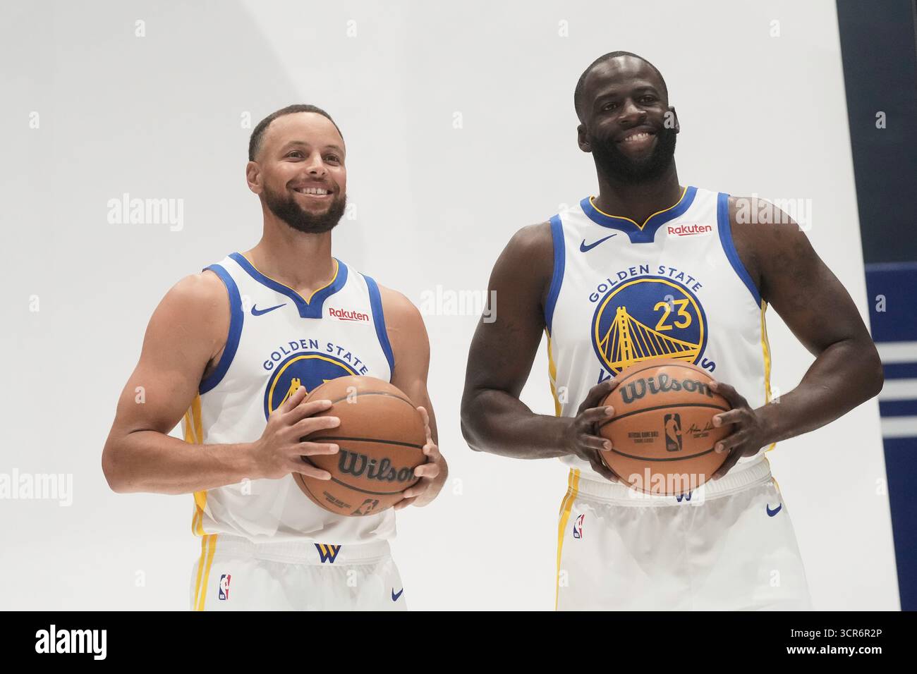 Golden State Warriors guard Stephen Curry, left, poses for photos with forward Draymond Green ...