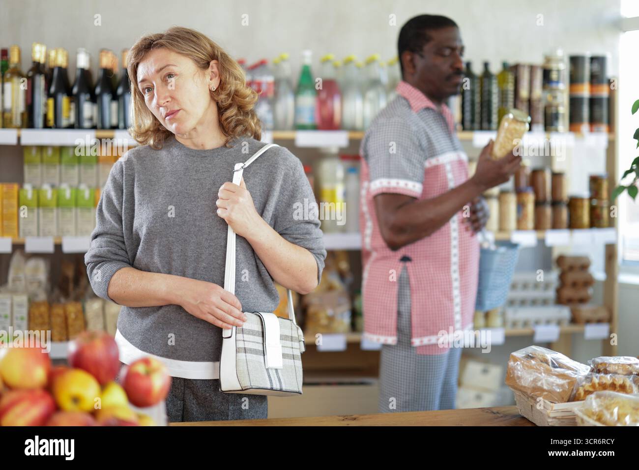 Female shopper looks products hi-res stock photography and images - Alamy