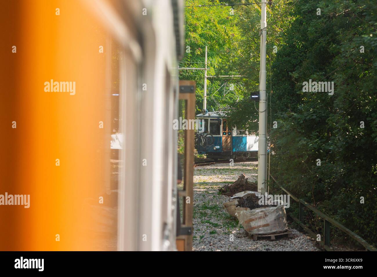 the Opicina Tram, a historic tram line, ascending a hill. The orange ...