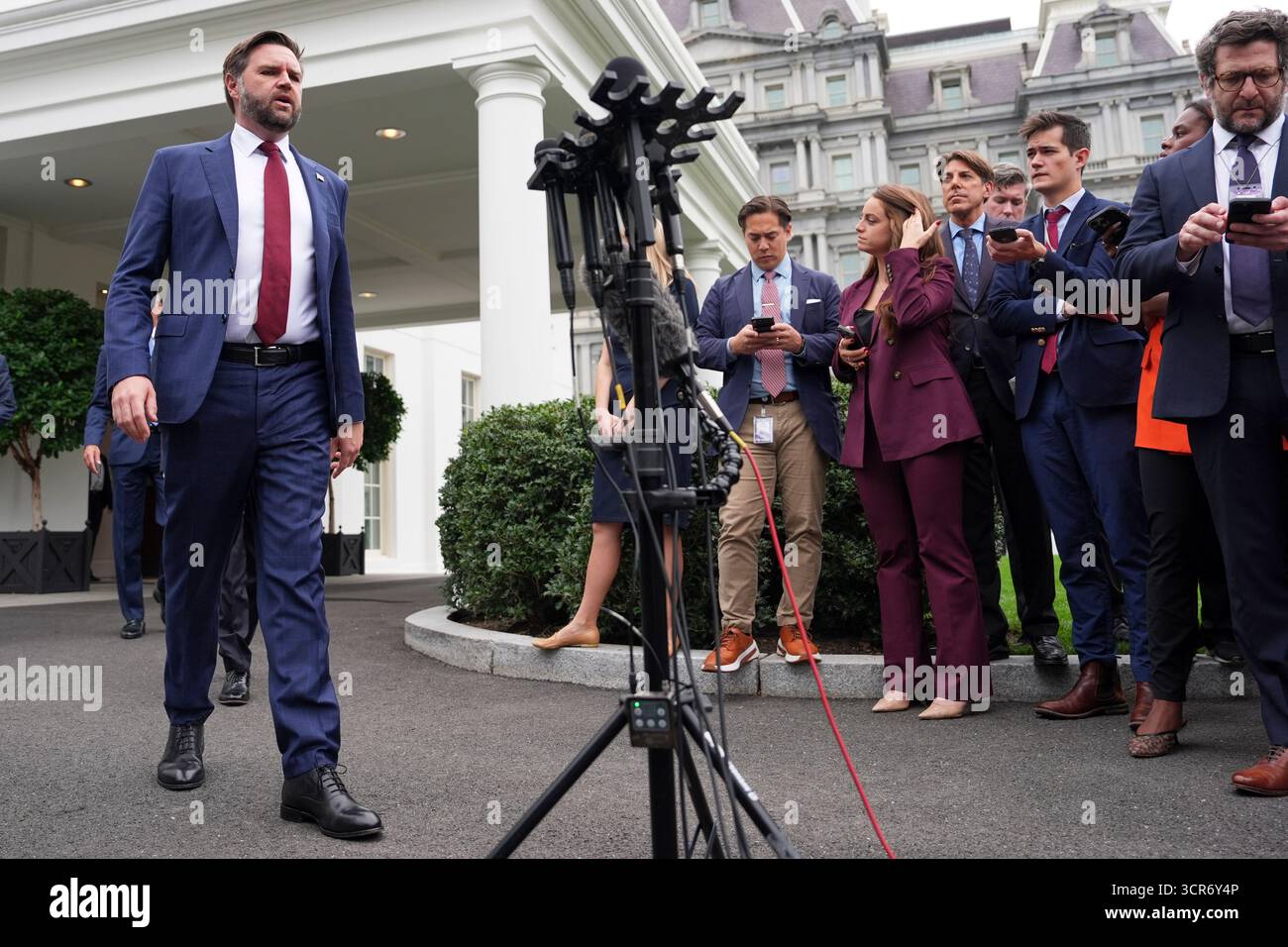 Vice President JD Vance walks to speak to members of the media outside ...