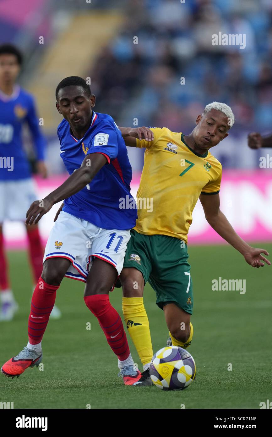 France's Tadjidine Mmadi, left, fights for the ball with South Africa's ...
