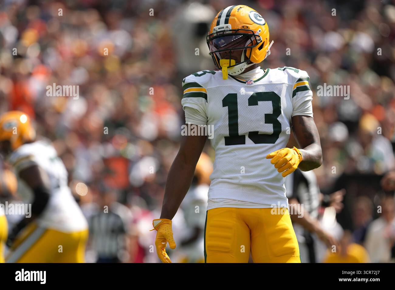 Green Bay Packers wide receiver Dontayvion Wicks (13) jogs to the line ...