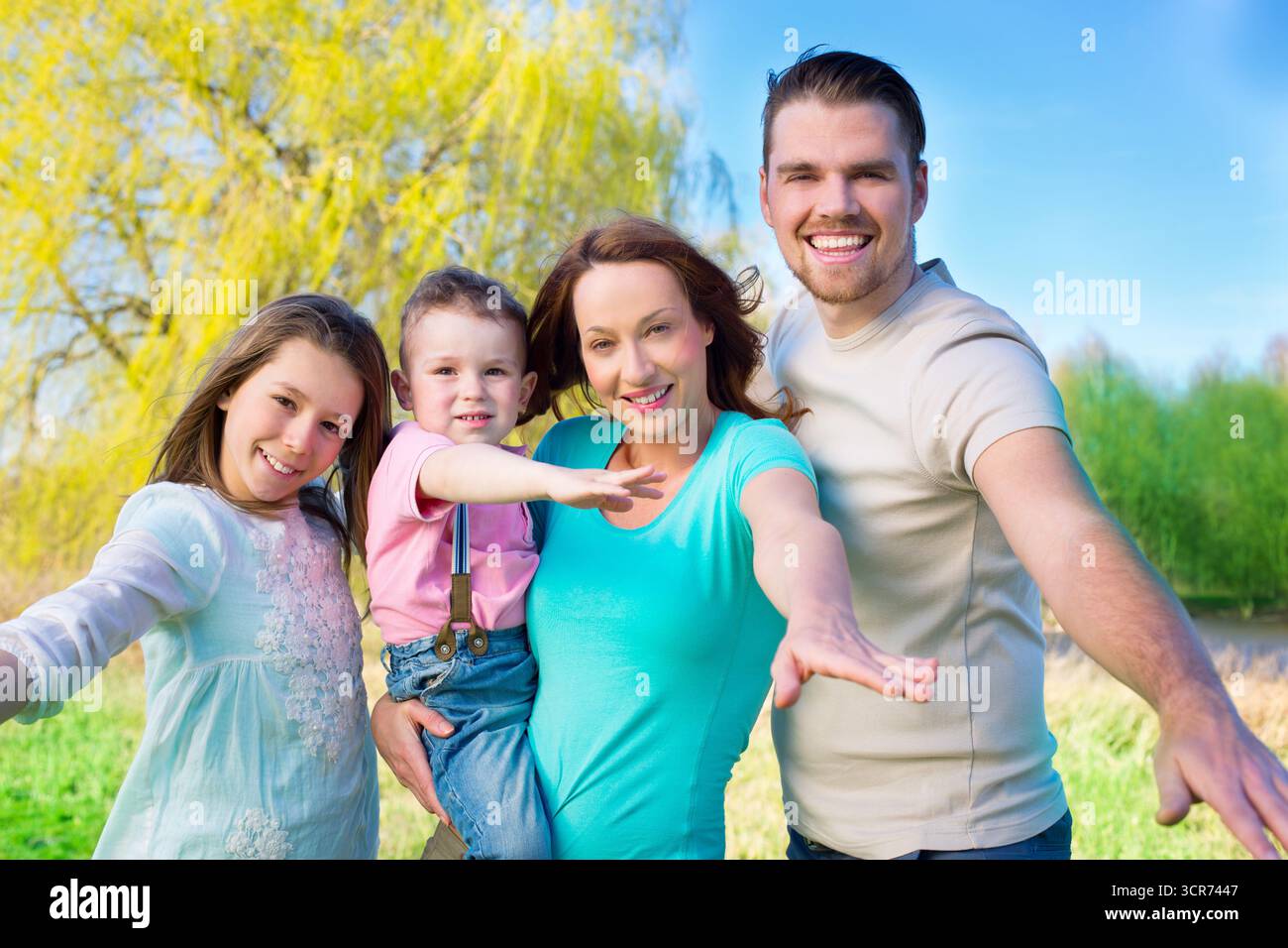 Family with two children on a meadow Stock Photo - Alamy