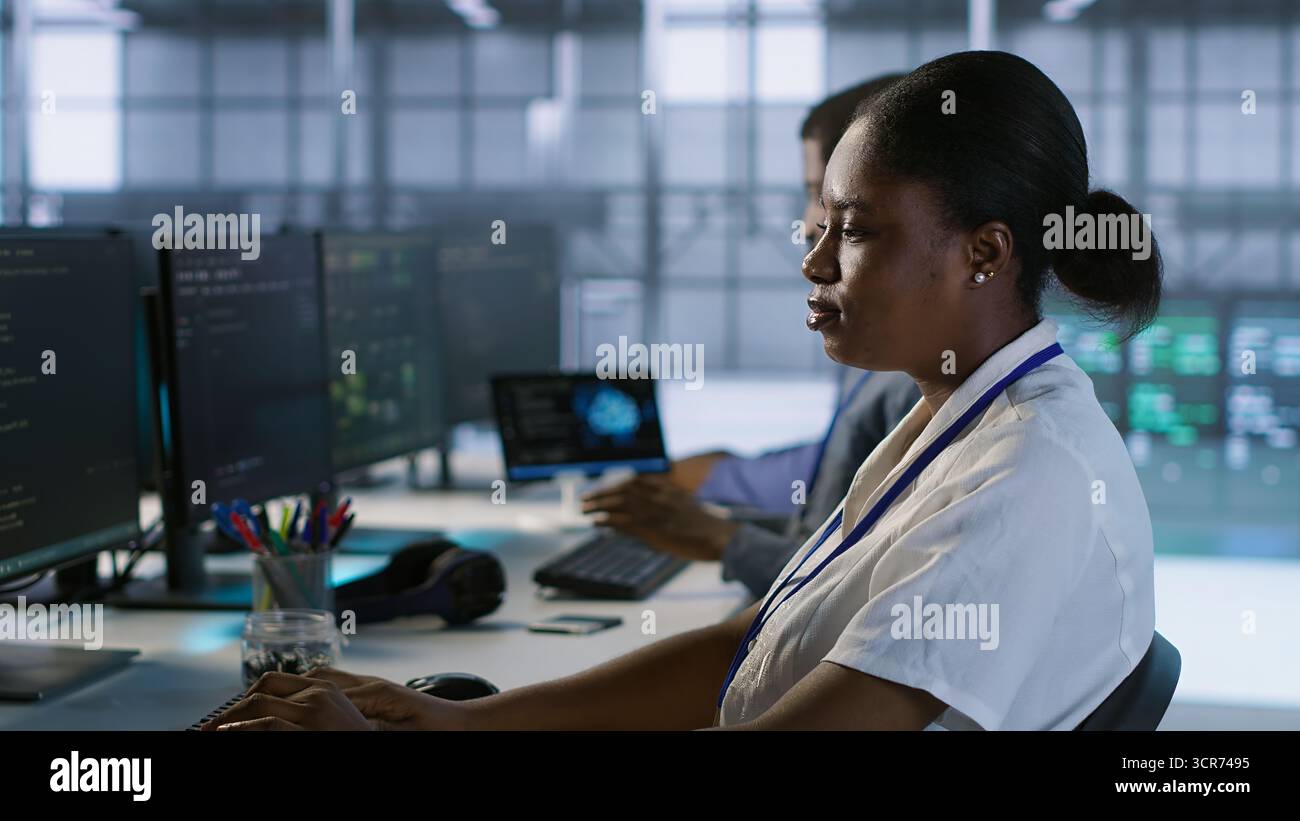 Computer scientists in data center implementing AI predictive maintenance systems. Server farm ...