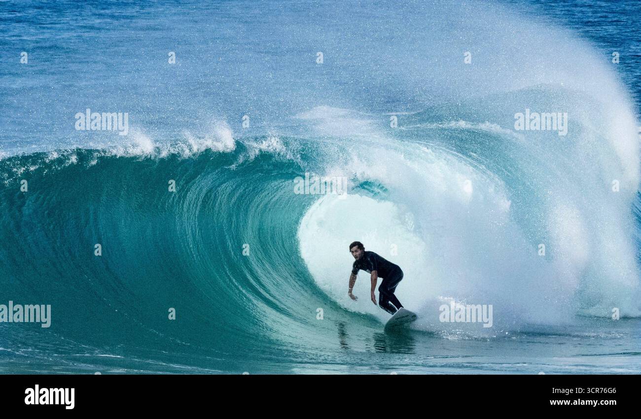 A surfer rides a wave at the Wedge in Newport Beach, Calif., Monday ...