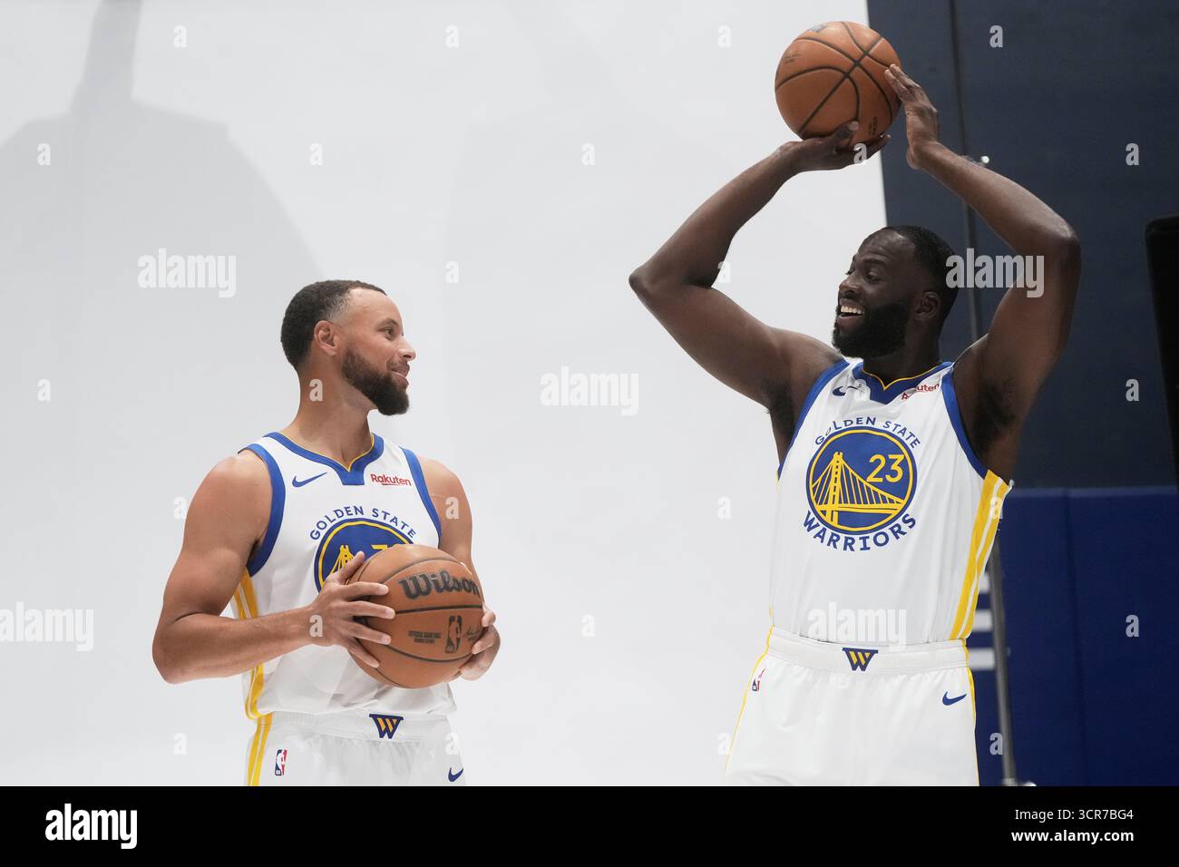 Golden State Warriors guard Stephen Curry, left, and forward Draymond Green (23) pose for photos ...