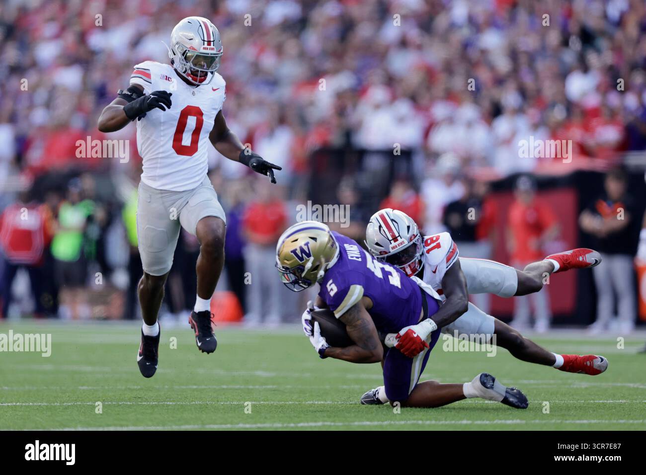 Washington wide receiver Omari Evans (5) is tackled by Ohio State ...