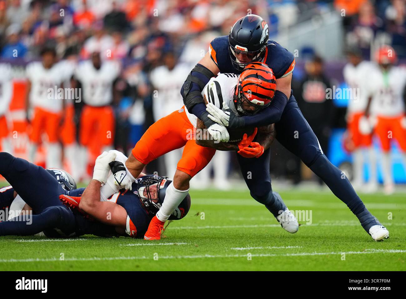 Cincinnati Bengals running back Chase Brown (30) is tackled by Denver ...