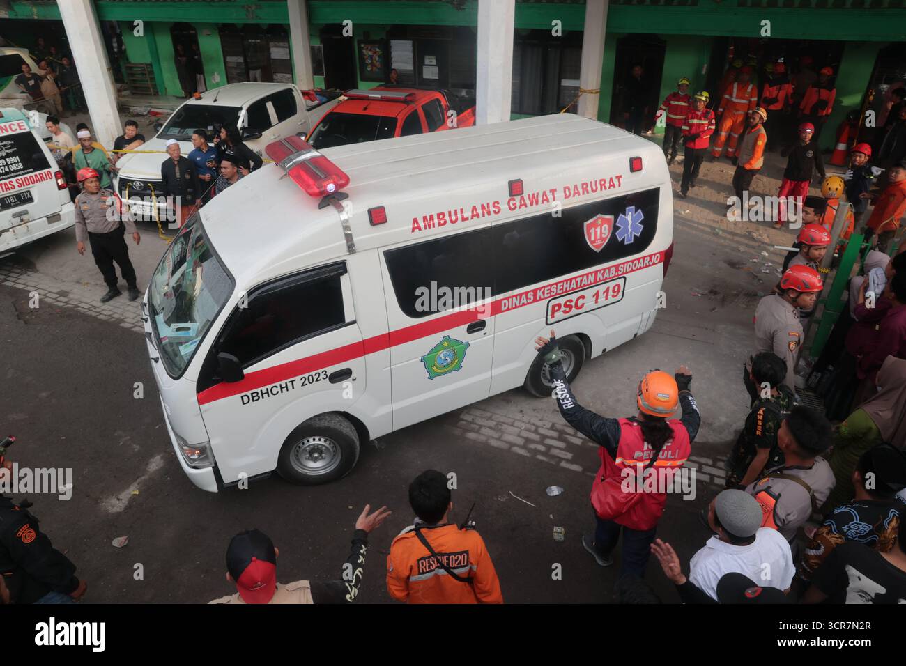 An ambulance parks outside the compound where a building under ...