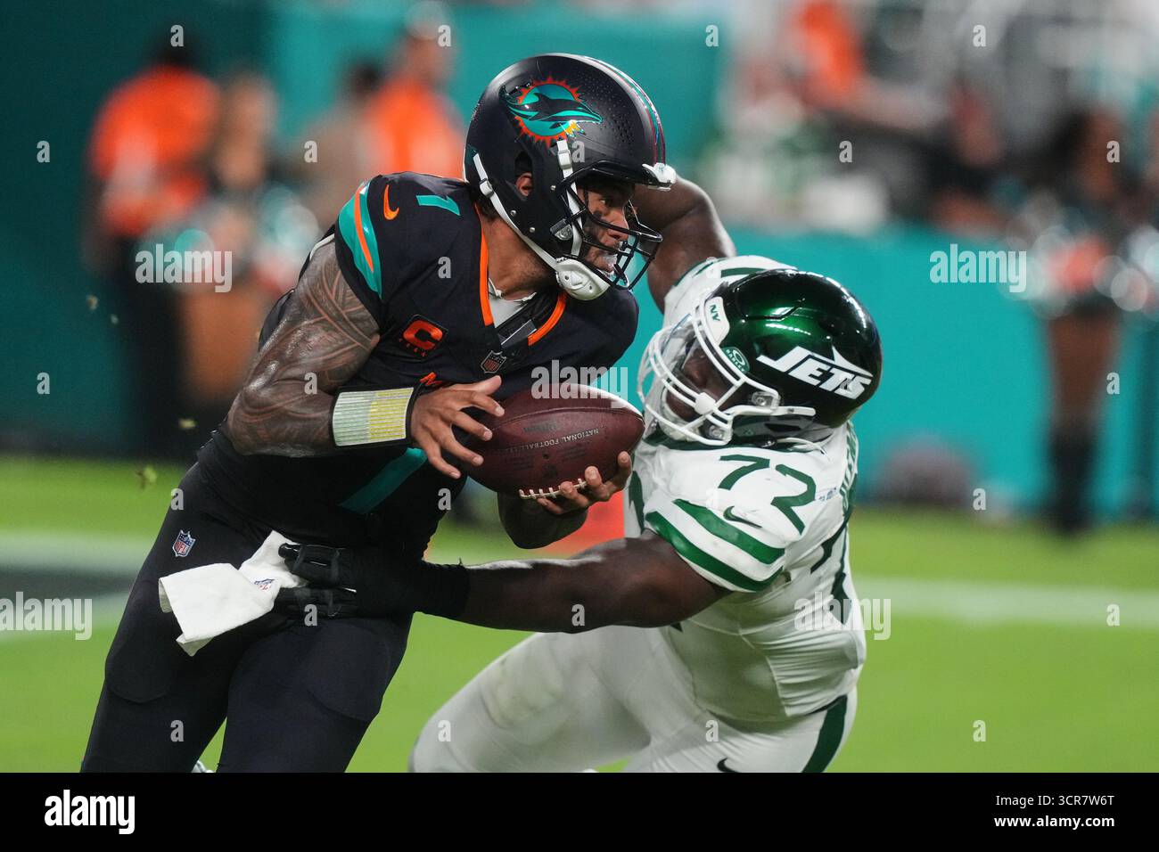 Miami Dolphins quarterback Tua Tagovailoa (1) is pressured by New York ...