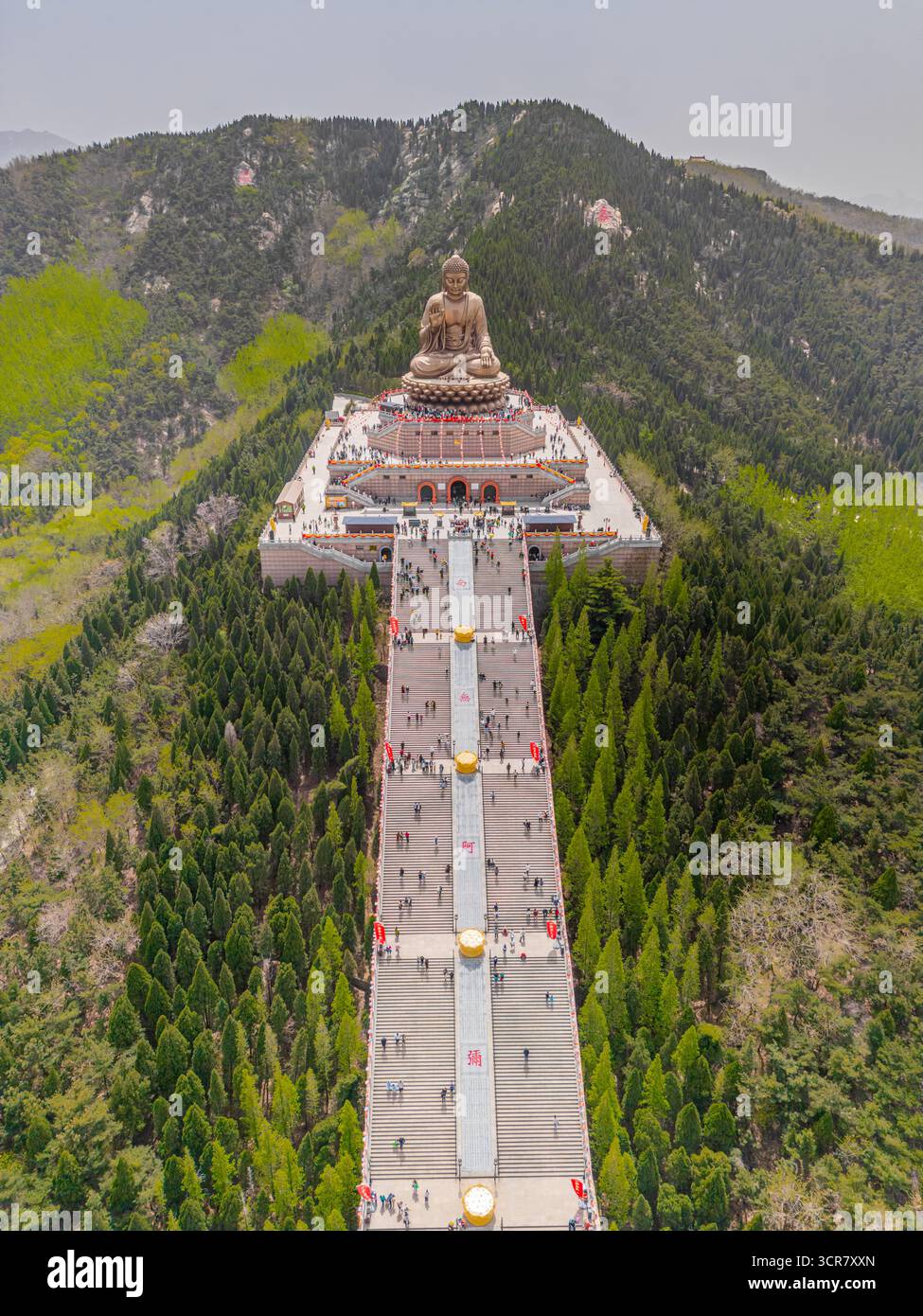 Nanshan great Buddha, in China. People climbing the stairway to reach ...