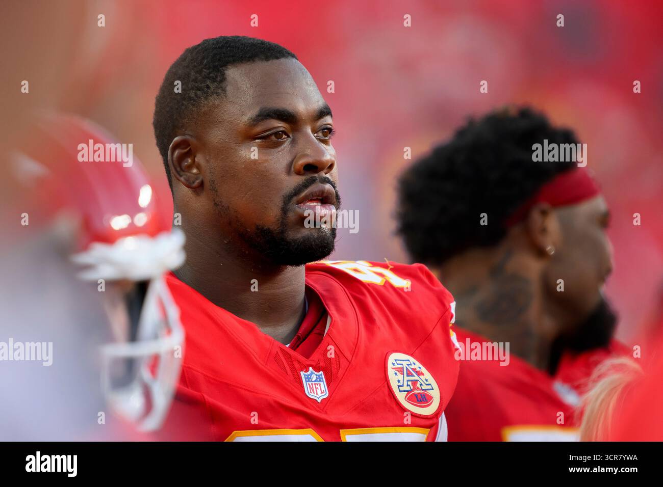 Kansas City Chiefs defensive end Chris Jones watches from the sidelines ...