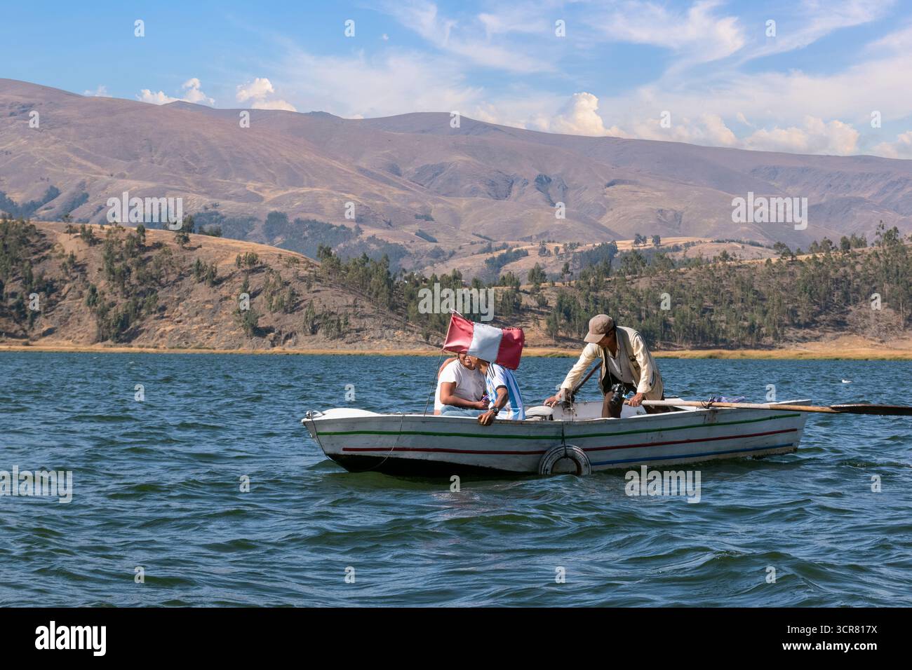 Anonymous man in a motorboat on the calm waters of a lake Stock Photo ...
