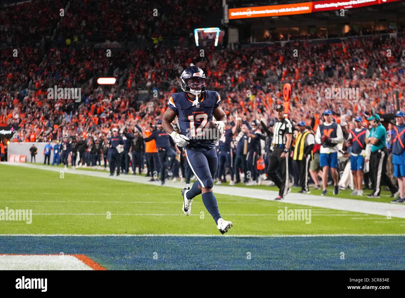 Denver Broncos linebacker Nik Bonitto (15) runs for a touchdown against ...