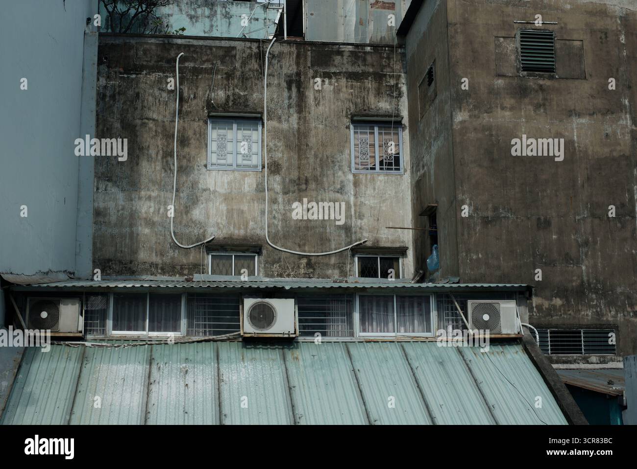 No people shot of old time-worn residential building with gray shabby ...