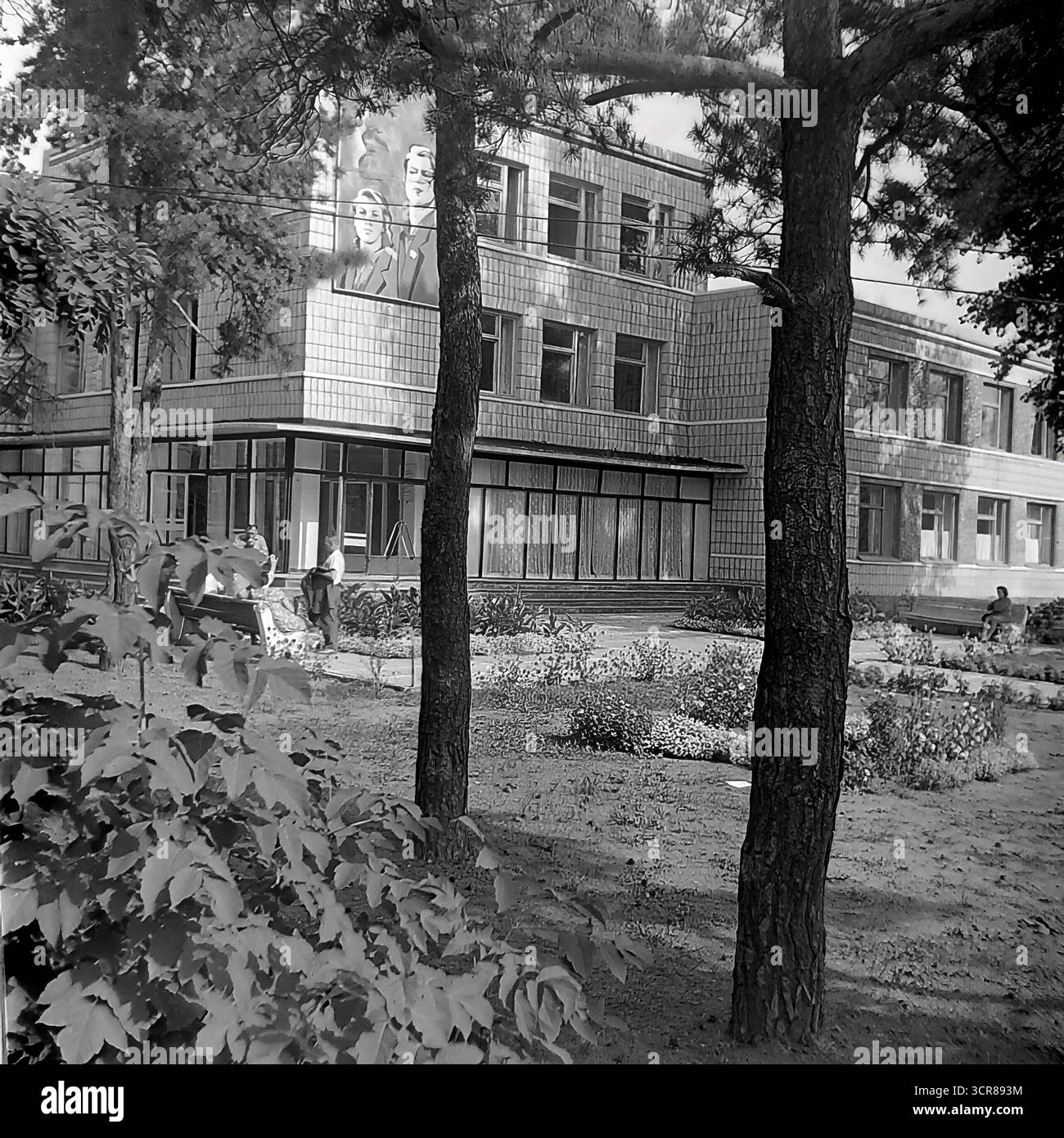 Vacationers relax in the park surrounding the 'Slavyansky' sanatorium ...