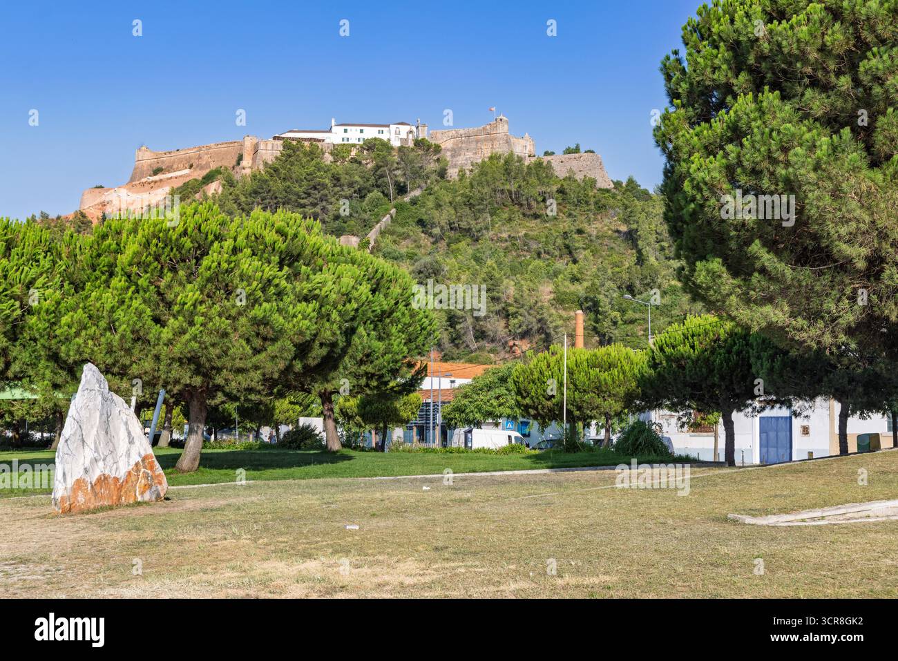 The historic São Filipe Fort sits on a green hill overlooking the city ...