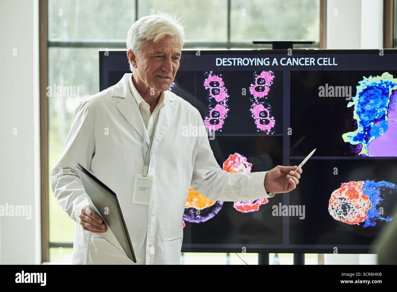 Senior Caucasian male professor presenting scientific research, holding ...