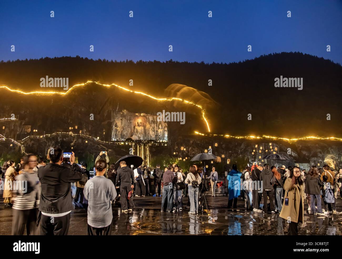Tourists visit the Longmen Grottoes scenic area at night in Luoyang ...