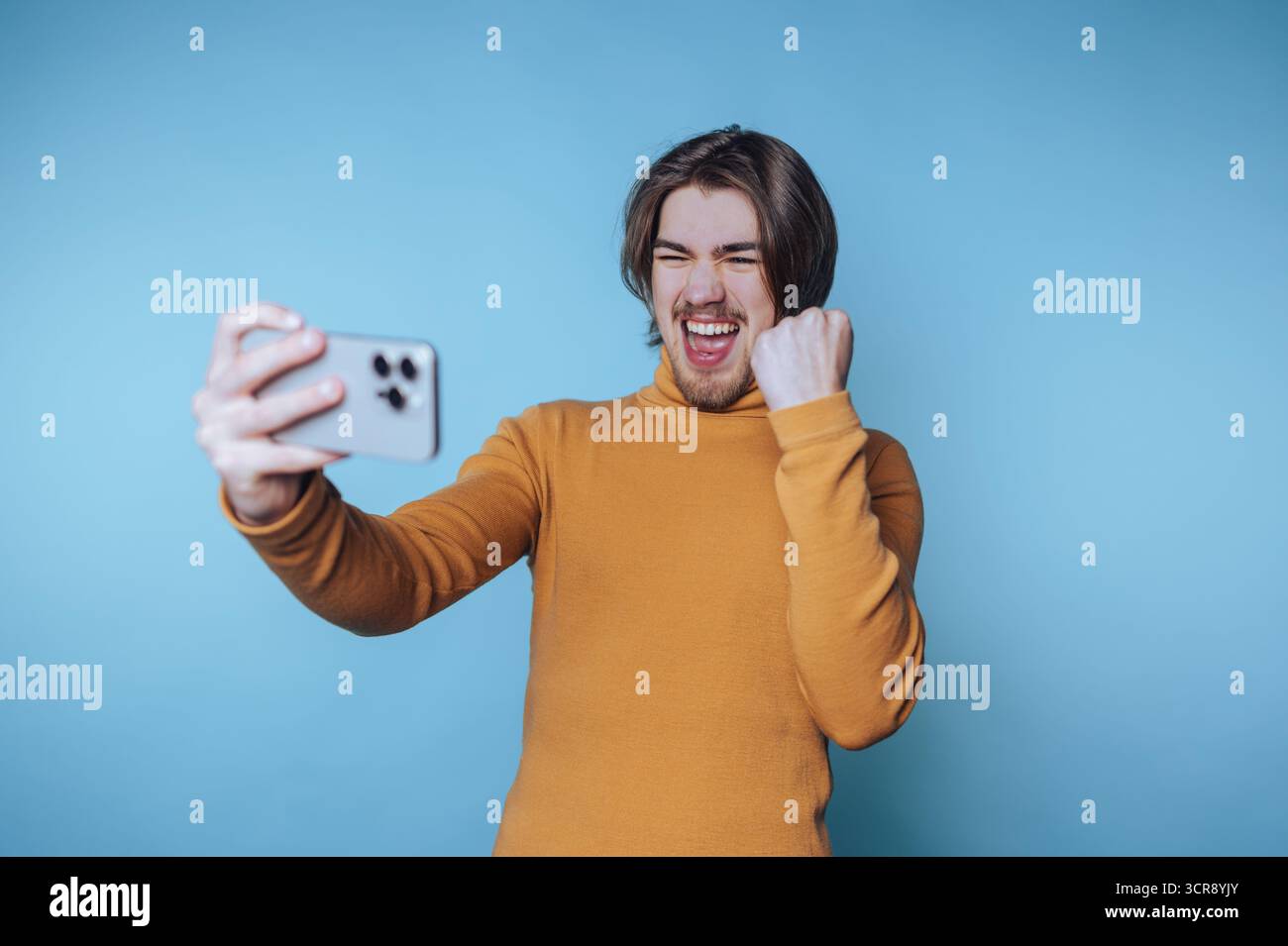 Young man excitedly taking hi-res stock photography and images - Alamy