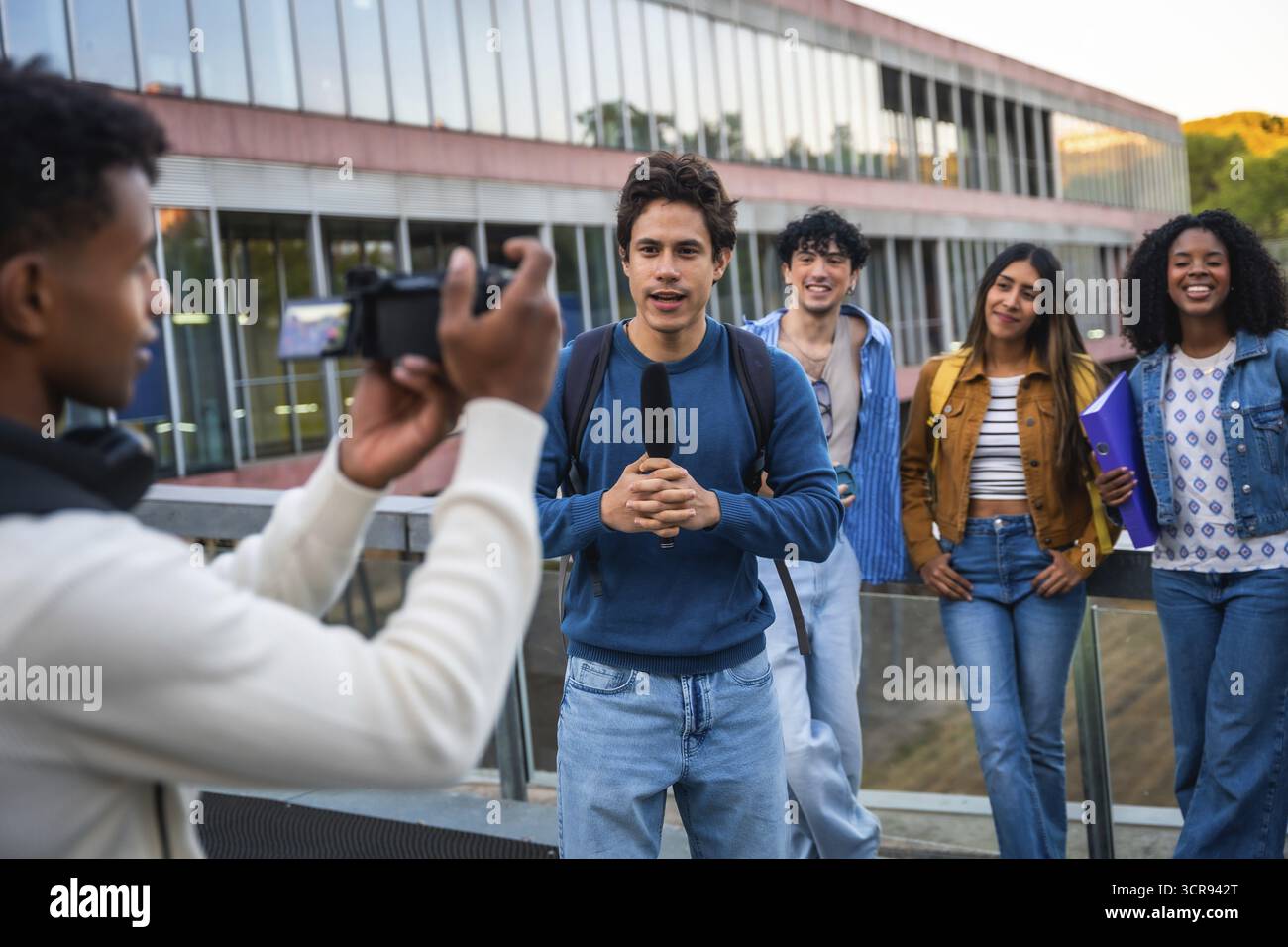 Group of diverse university students collaborating, with one student ...