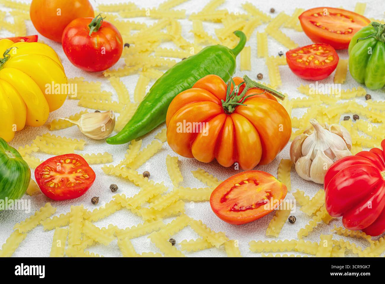 Raw mafalda corta pasta with assorted heirloom tomatoes, garlic, chili ...