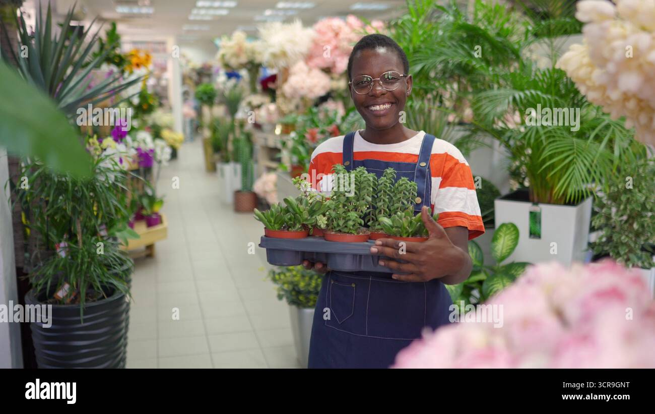 Young florist holding tray small hi-res stock photography and images ...