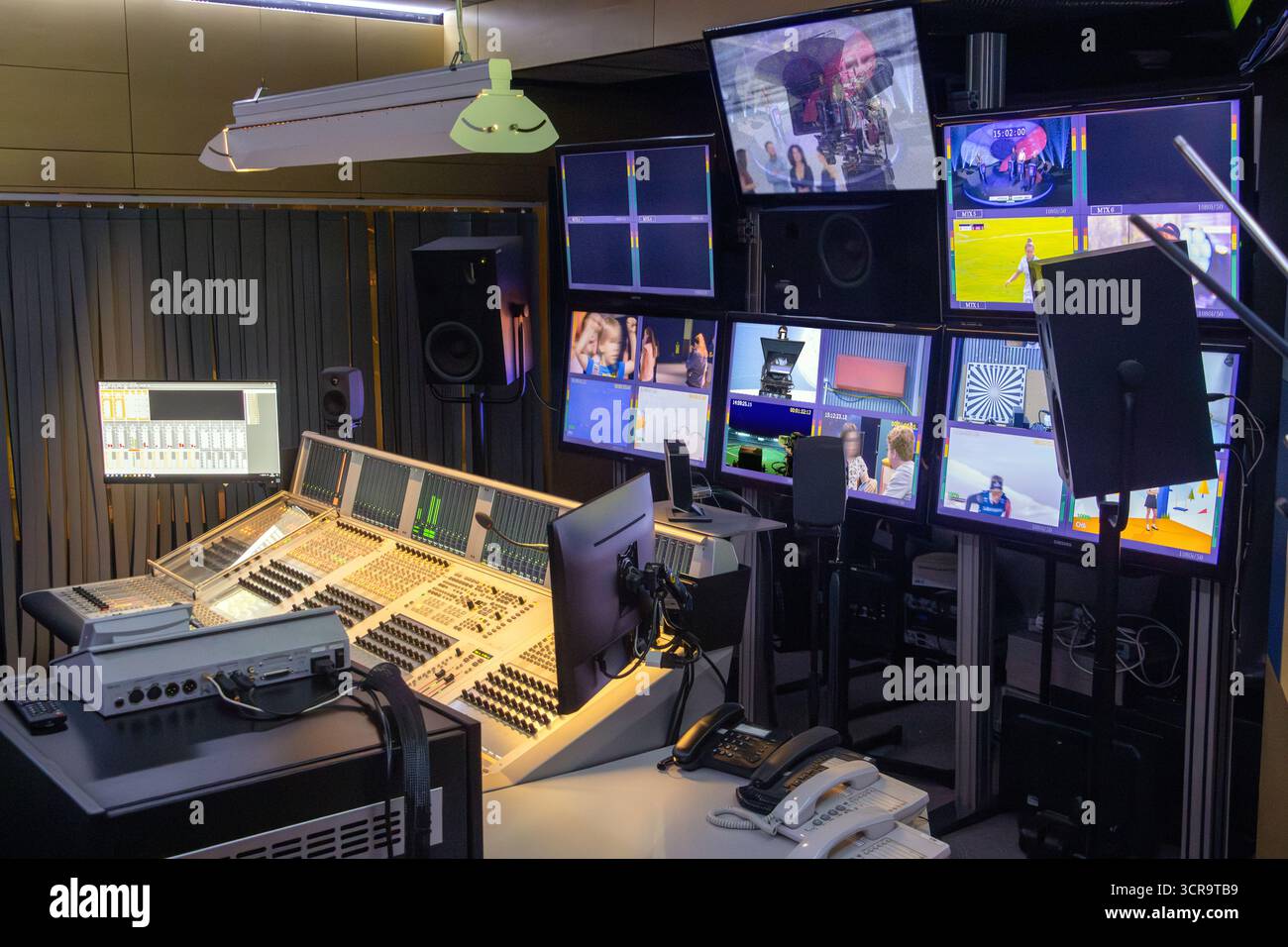 Interior view of a fully equipped broadcast studio with multiple ...