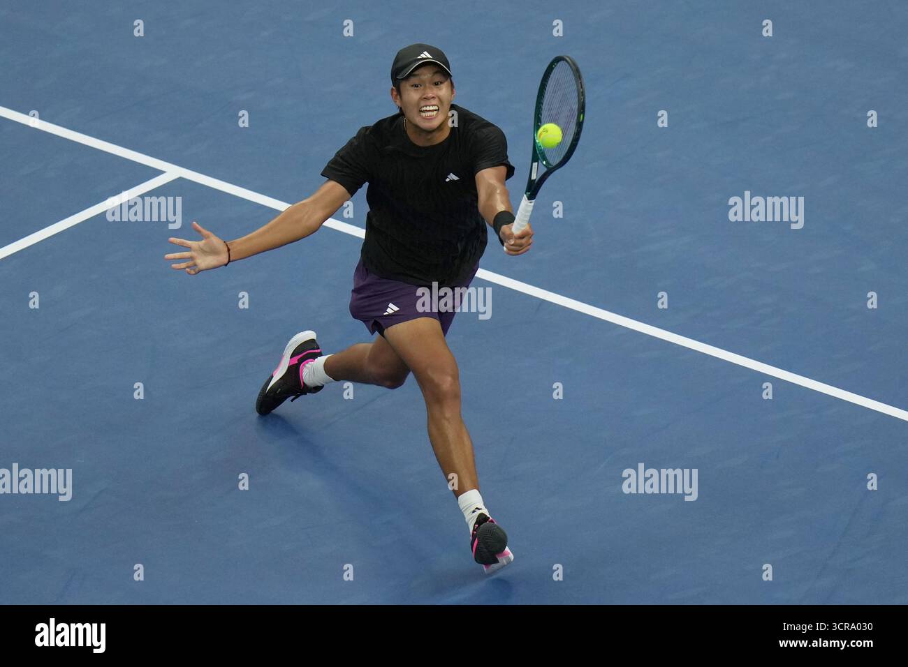 Learner Tien, of the United States returns a backhand shot from Daniil ...