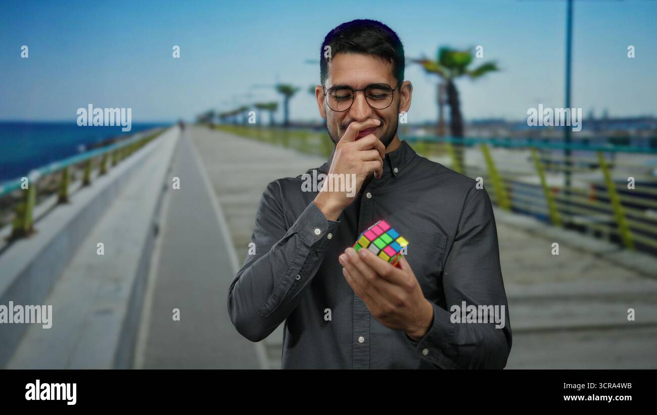 Man solving cube on seaside hi-res stock photography and images - Alamy